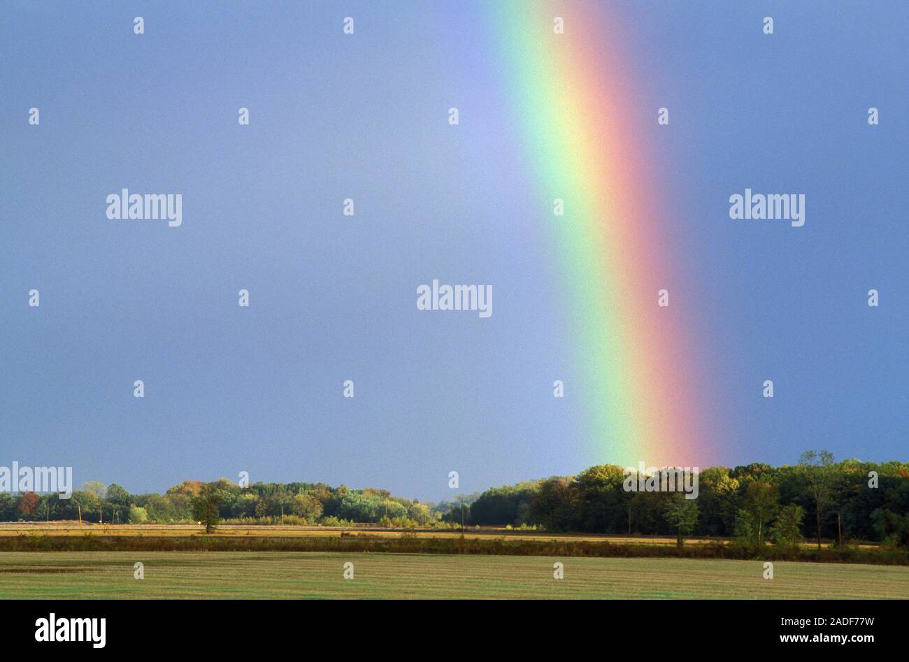 Rainbow over farmland. Rainbows occur when the observer is facing ...