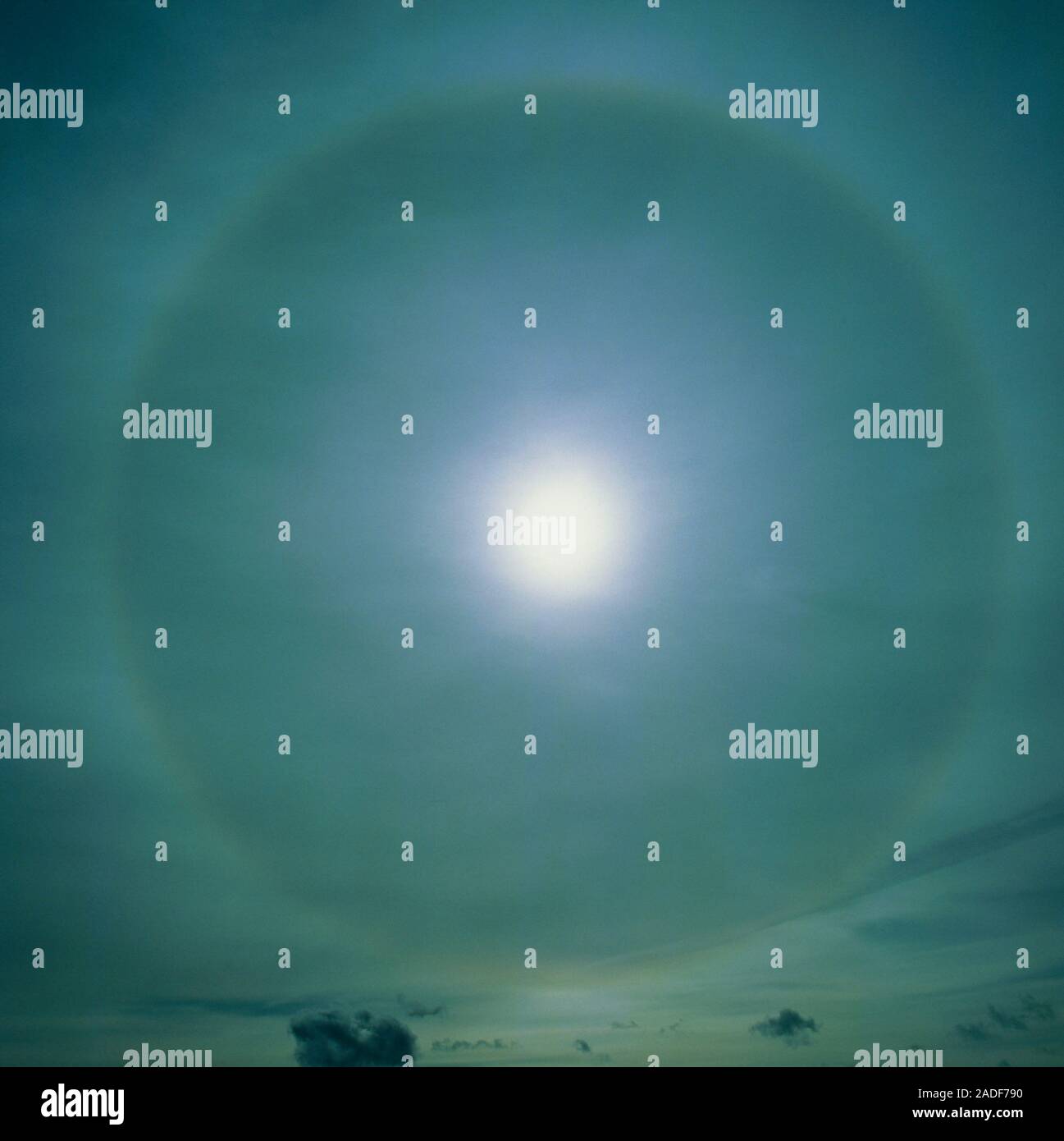 Photograph of a 22-degree diameter ice halo around the Sun. The halo is ...