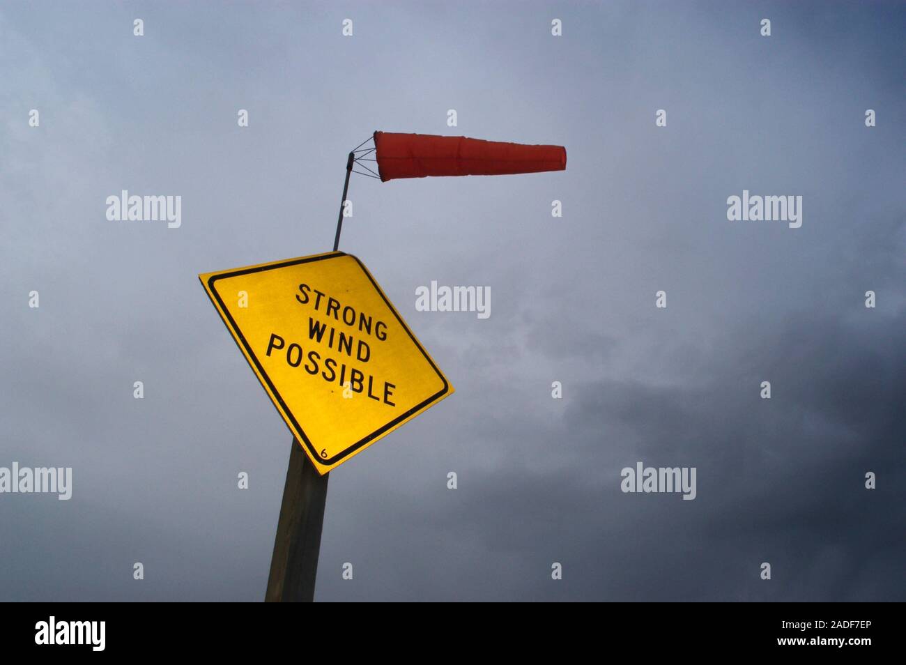 Wind sock and warning sign beneath a stormy sky. Photographed in ...