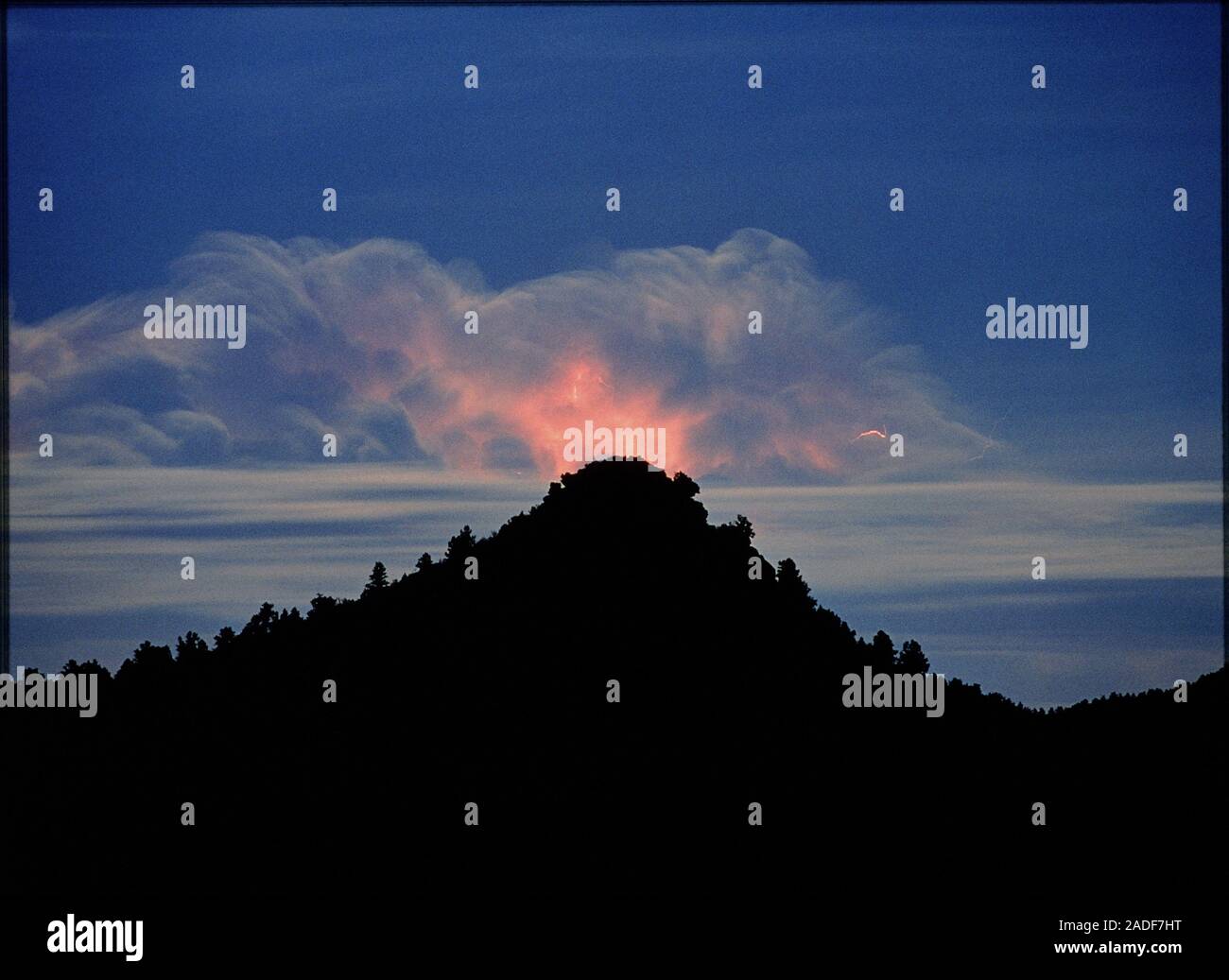 Lightning. Clouds lit up at night as lightning passes from one to ...