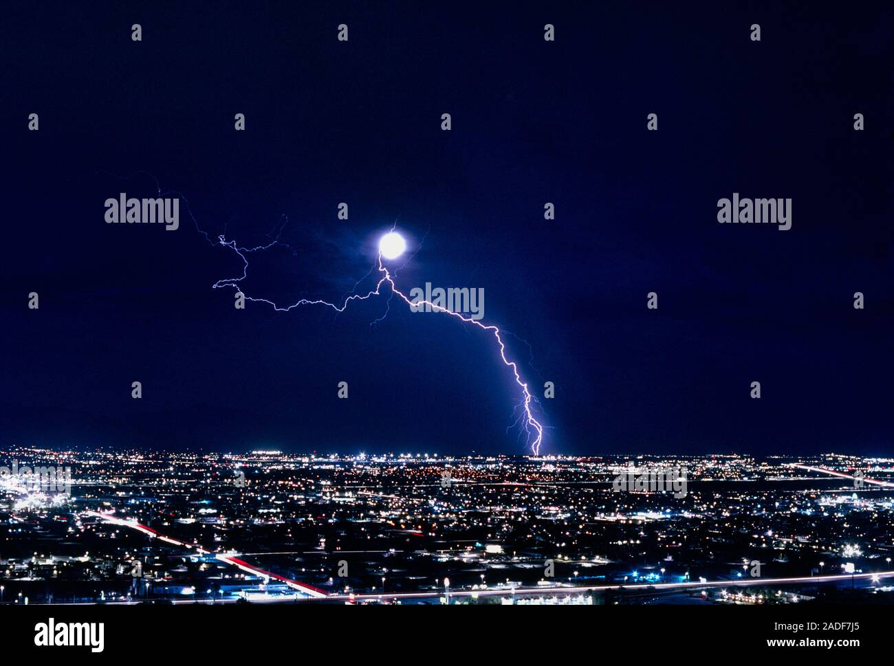 Lightning. Night-time view of a bolt of lightning striking the ground ...