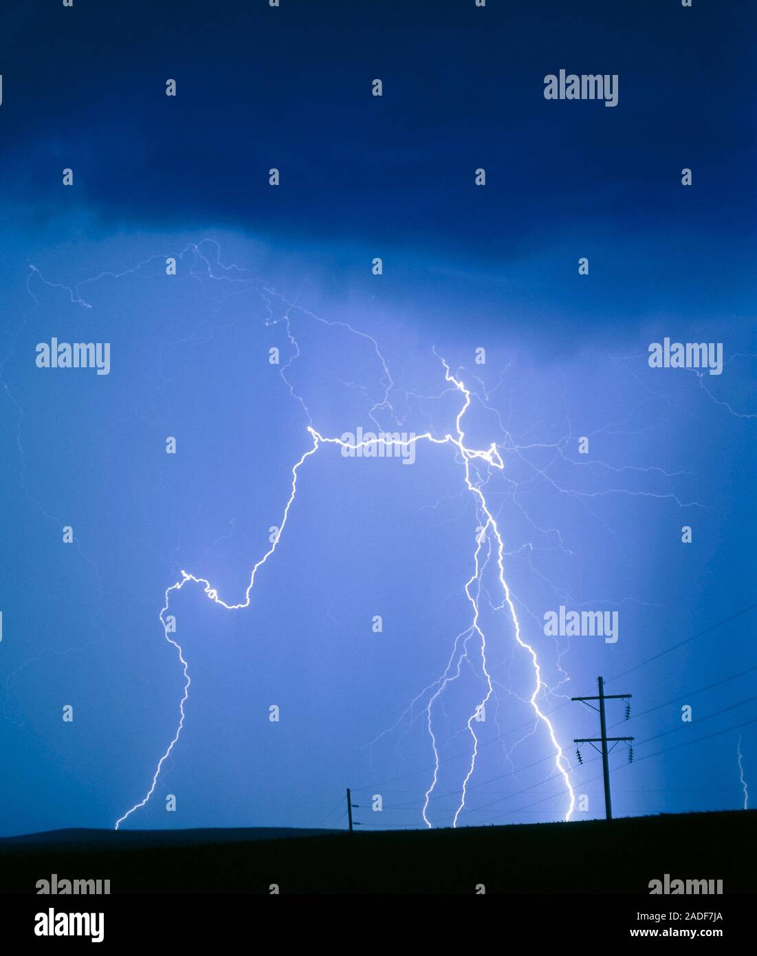 Lightning. Night-time view of a bolt of lightning striking the ground ...