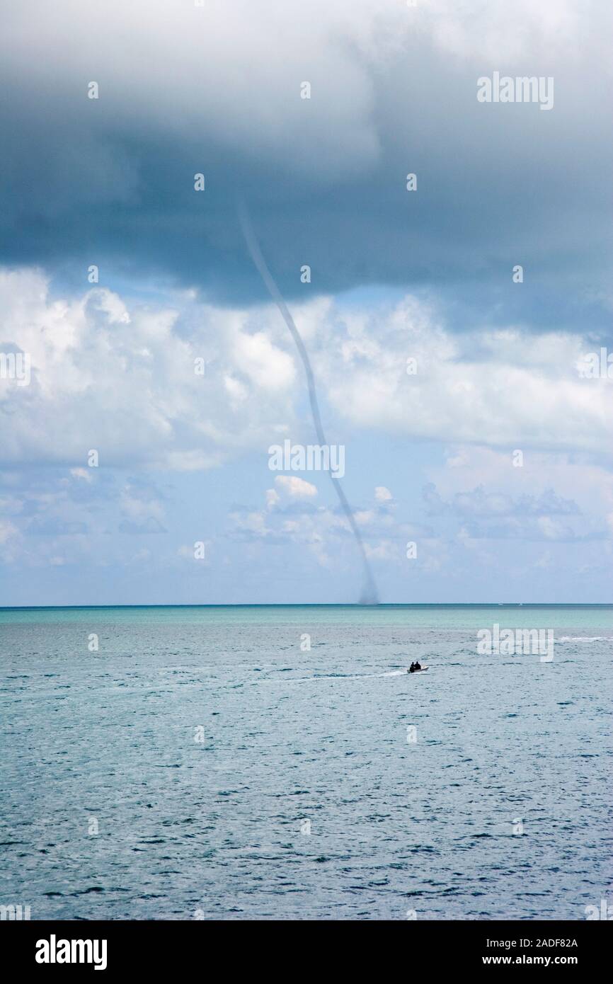 Waterspout forming over the sea. This non-tornadic formation is a ...