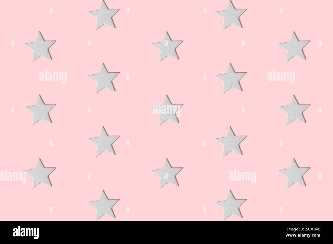 White decorative stars pattern on pastel pink background minimal ...