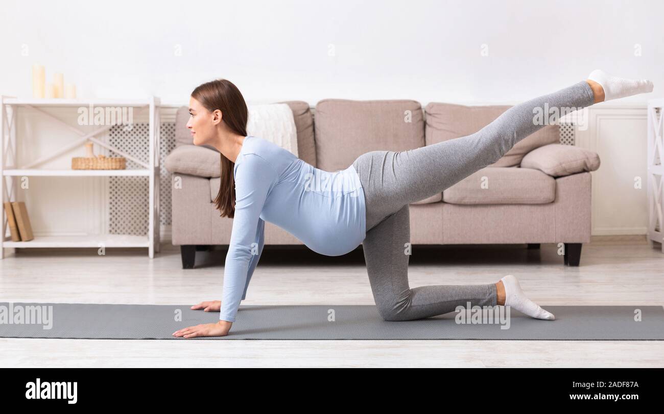 Athletic pregnant girl doing rear leg raise exercises Stock Photo - Alamy