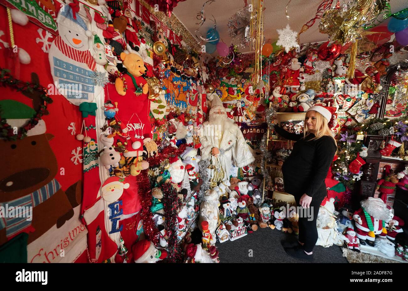 Victoria Burnham, 25, puts the finishing touches to hundreds of Santas ...