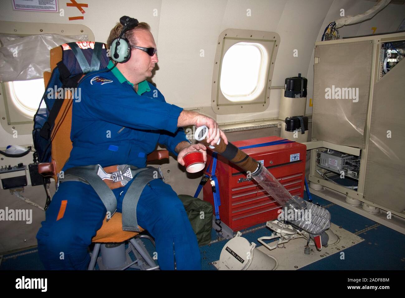 Hurricane researcher dropping a dropwindsonde probe from an aircraft ...