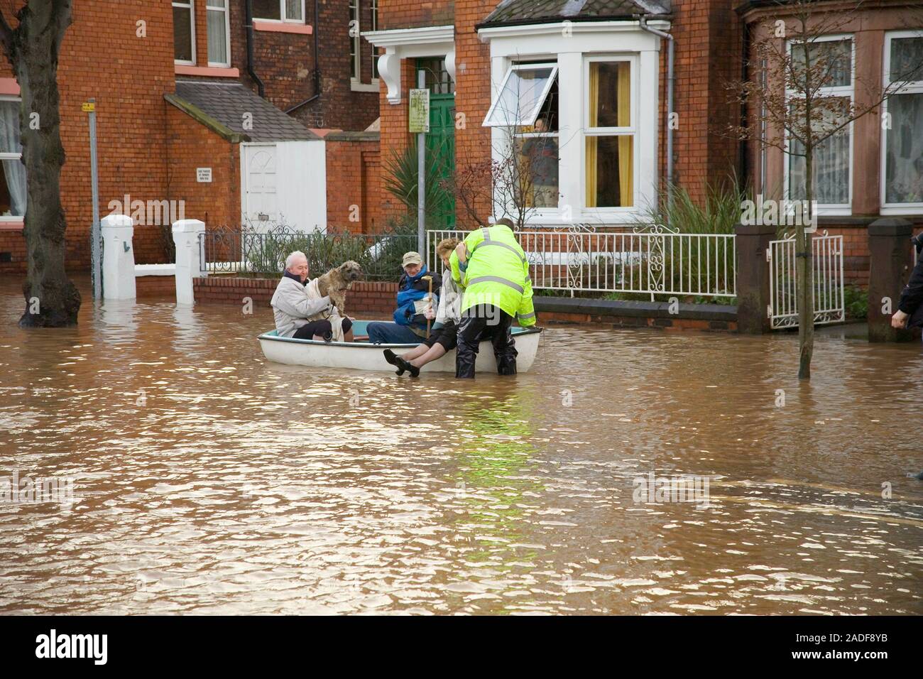 Evacuation of residents, Carlisle. Rescue worker evacuating residents ...