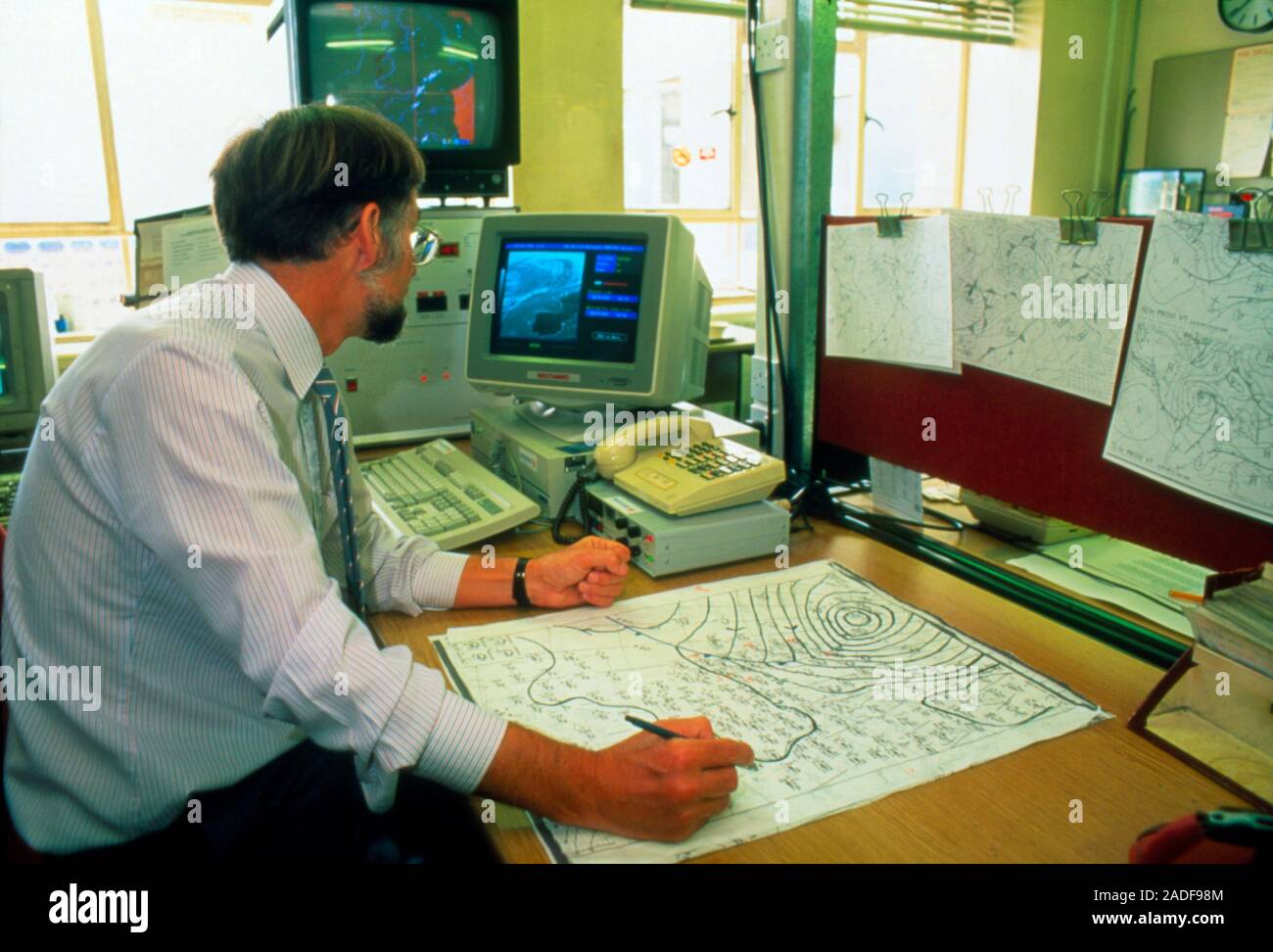 Weather forecasting. Meteorologist compiling a weather chart also known ...