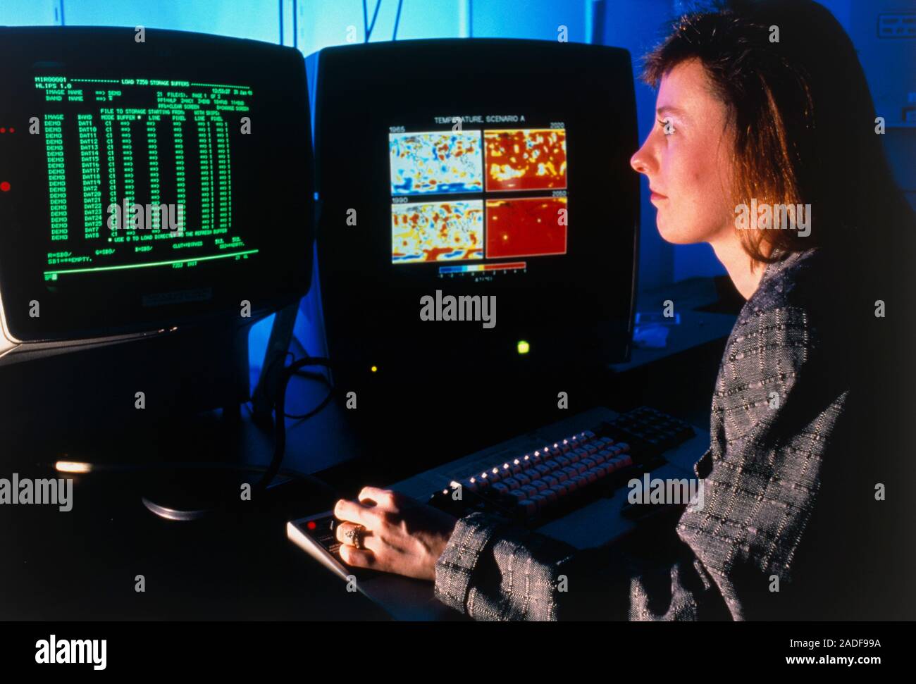 Global climate modelling. A climate researcher sitting at a workstation ...