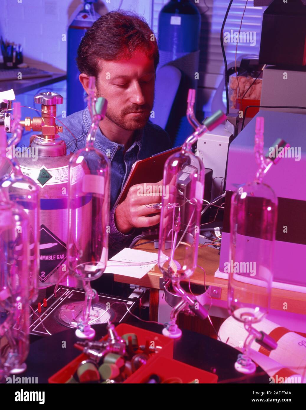 Air analysis. Scientist with equipment for analysing air by gas ...