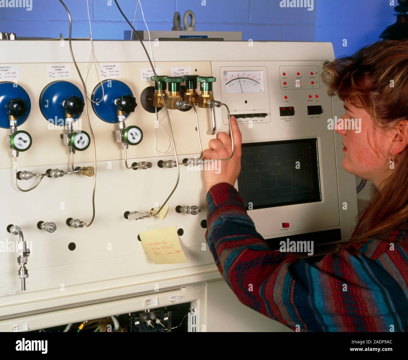 Carbon dioxide analysis. Scientist uses a mass spectrometer to analyse ...
