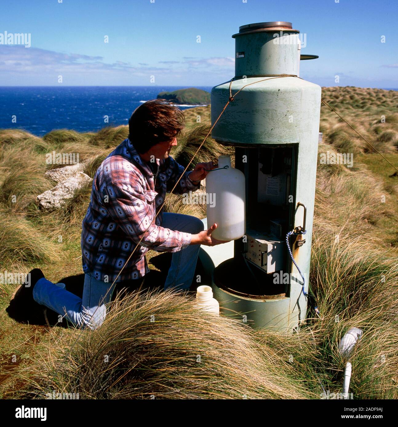 Rainfall sampler. Scientist collects the water from a rainfall sampler ...