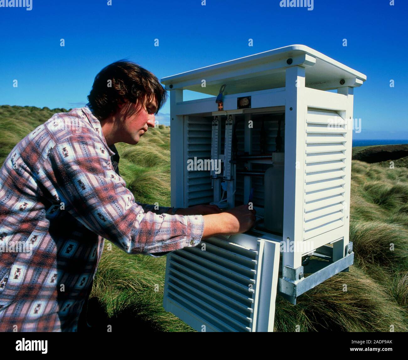 Weather station. Meteorologist notes the temperatures from thermometers ...