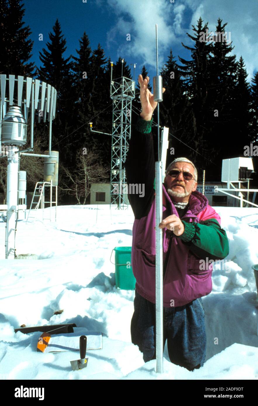 Snow research. Researcher measuring the density of snow. Photographed ...
