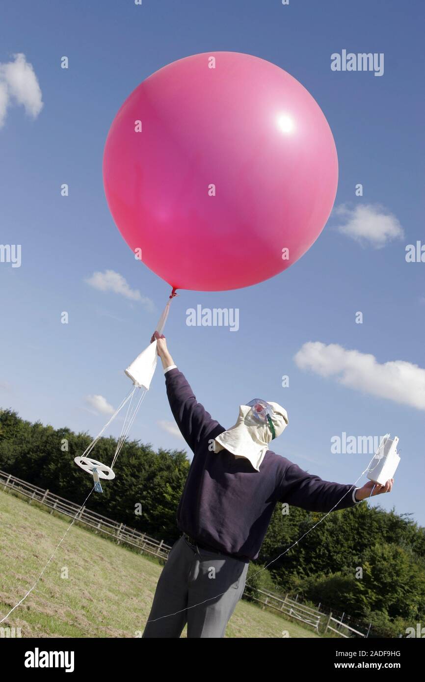 MODEL RELEASED. Weather balloon. Meteorologist launching a weather ...