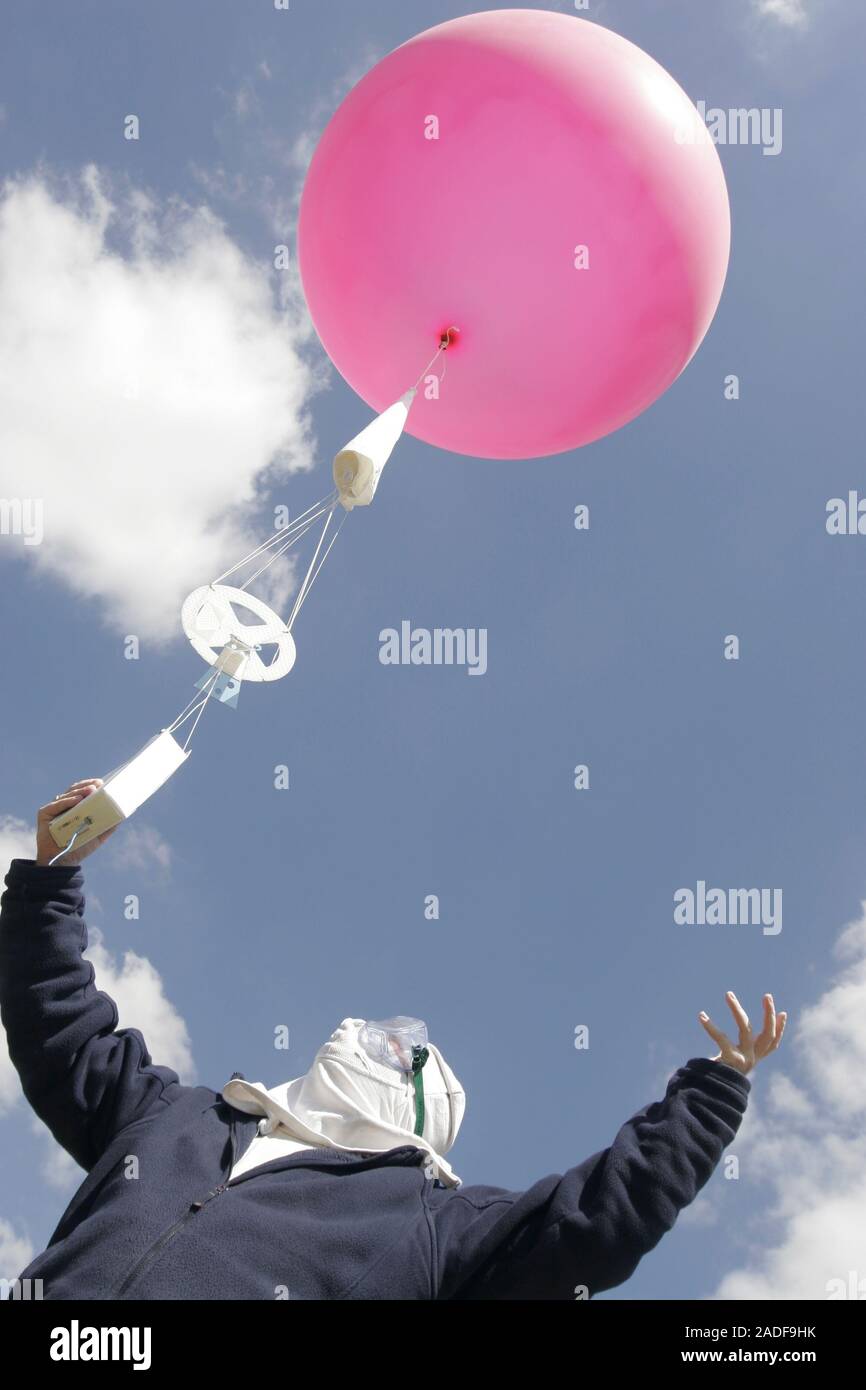 MODEL RELEASED. Weather balloon. Meteorologist launching a weather ...