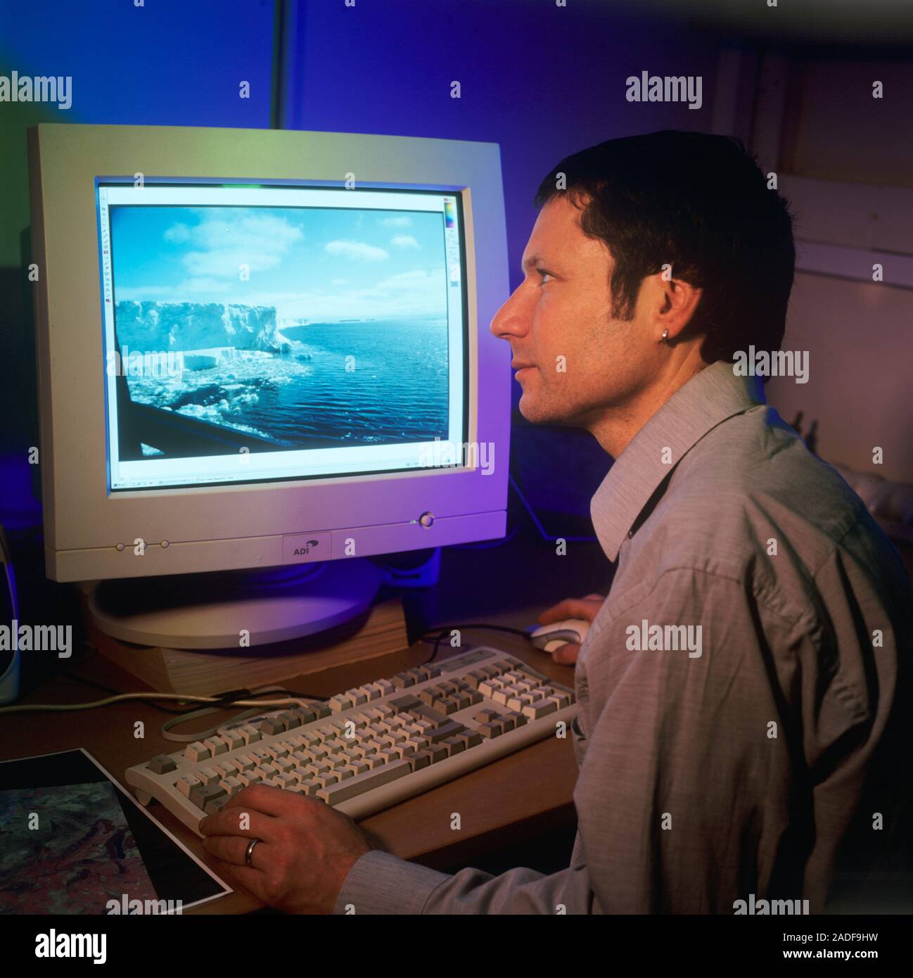 Climate change research. Researcher working at a computer with an ...