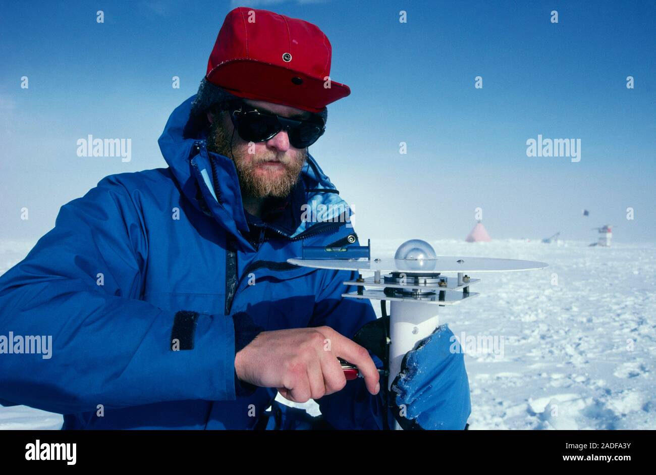 Sunlight research. Researcher setting up a sunshine recorder on ...