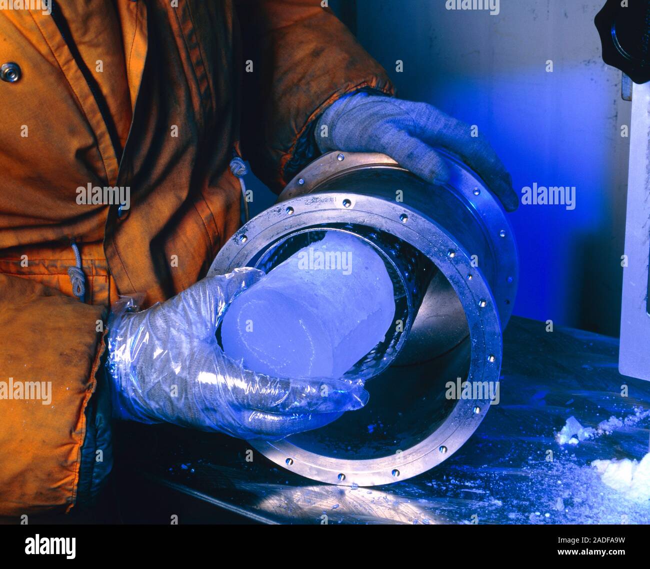 Ice core being handled in a cold room. The ice core will be crushed so ...