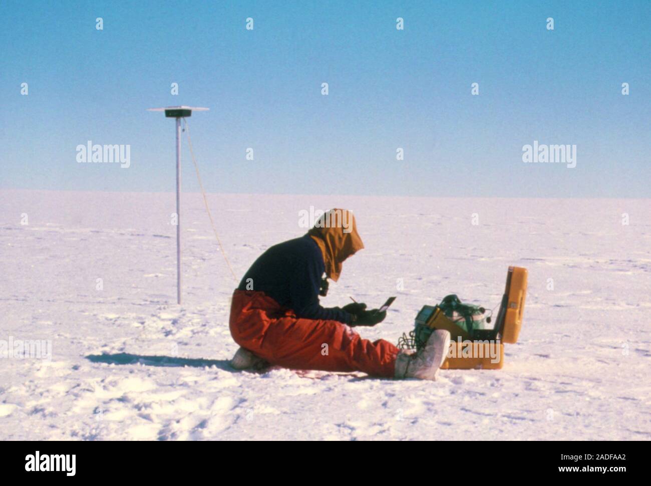 Measuring glacier speed. Glaciologist uses a Glo- bal Positioning ...