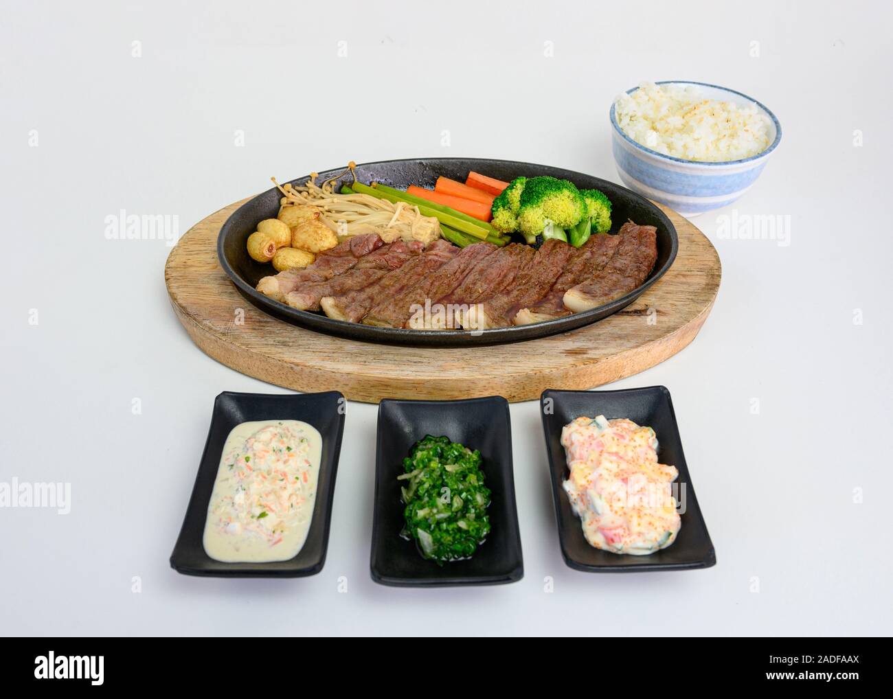 Japanese wagyu beef slices set with vegetables and sauce in pan on ...