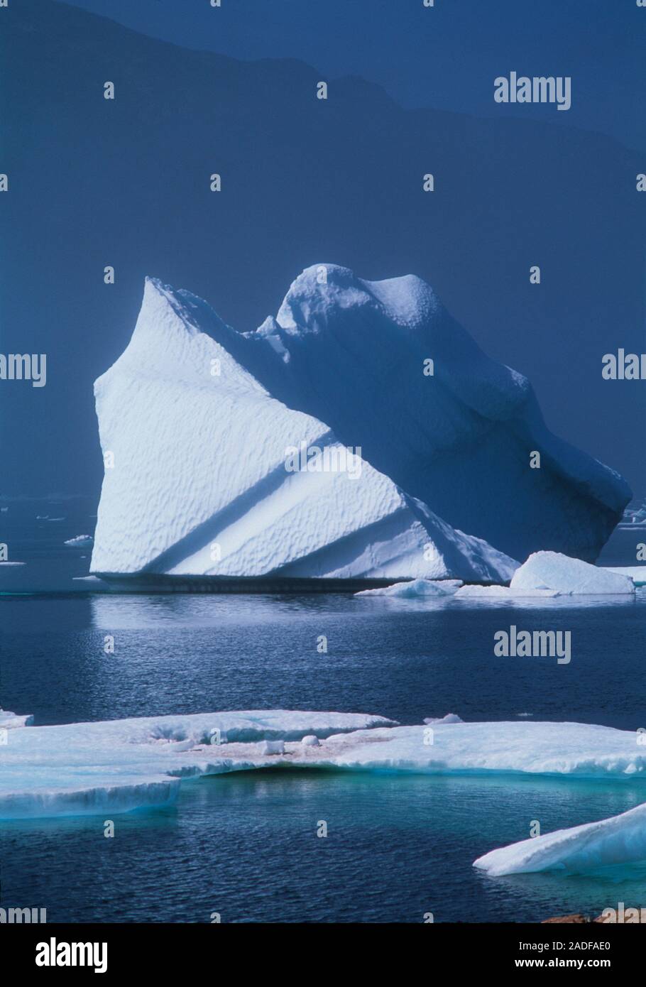 Iceberg (upper frame). This huge chunk of floating ice has broken away ...