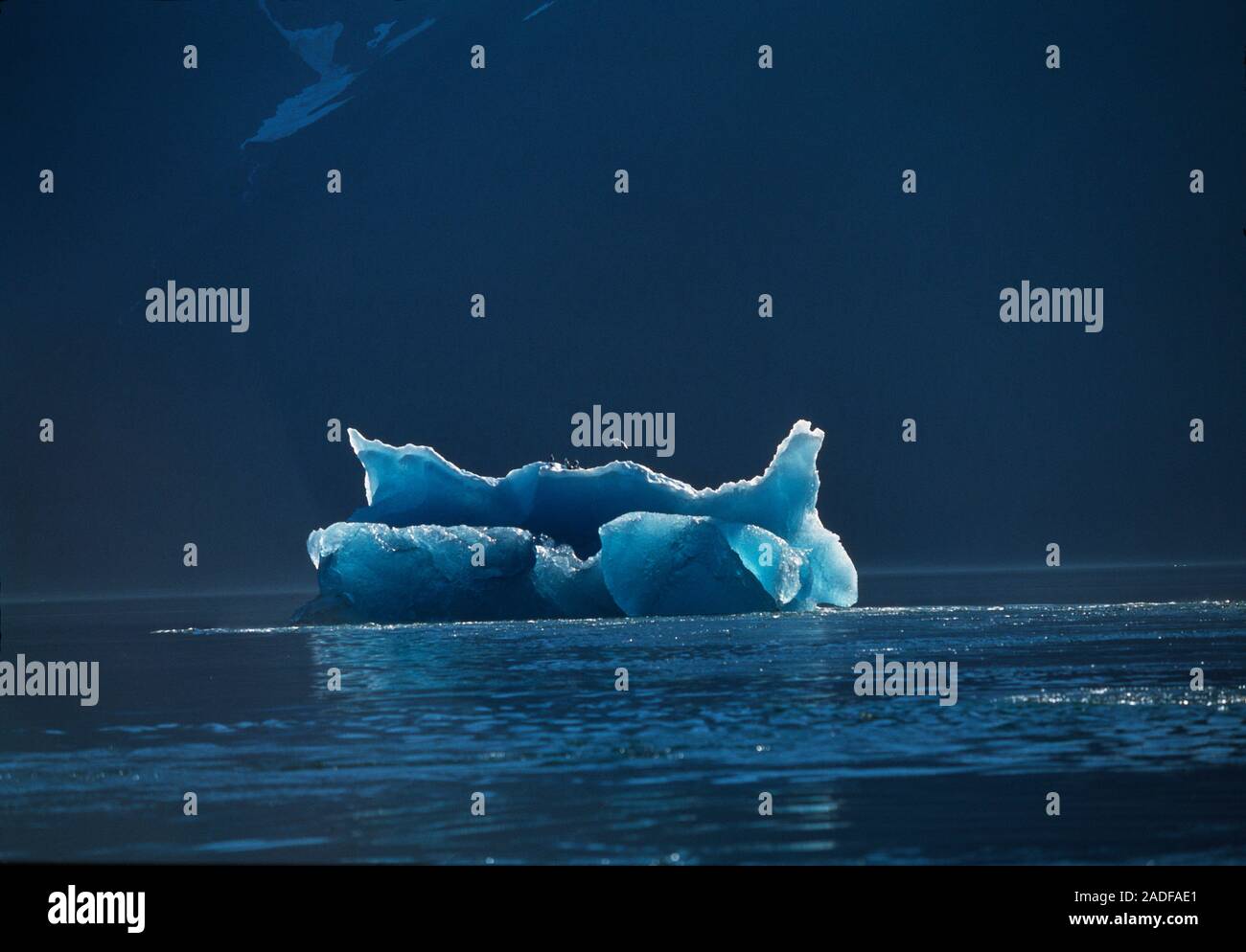 Stranded iceberg in shallow water. This chunk of ice broke away from a ...