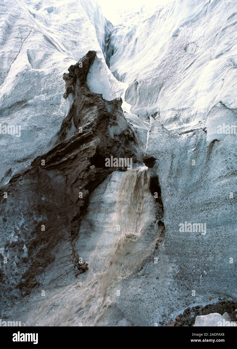 Melting glacier. Meltwater stream on the surface of a glacier. A glacier is a huge mass of ice ...