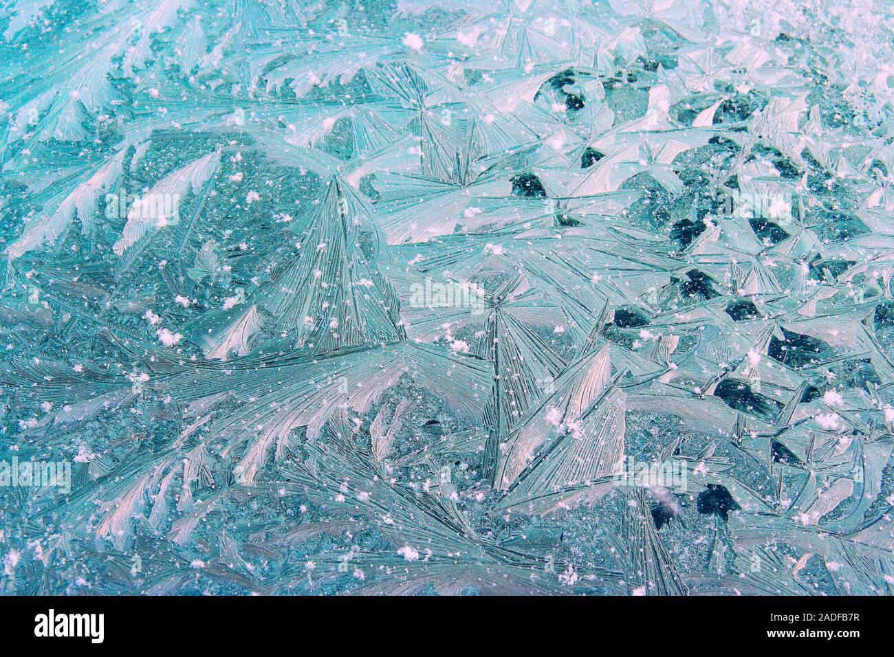 Ice patterns on a car windscreen. The ice formed overnight as ...