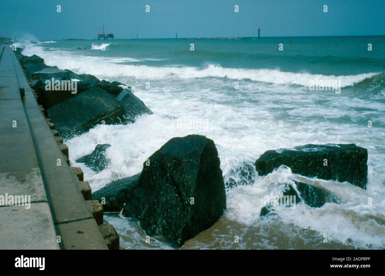 Sea Defences. Beneath an overcast sky, sea defences (consisting of a ...