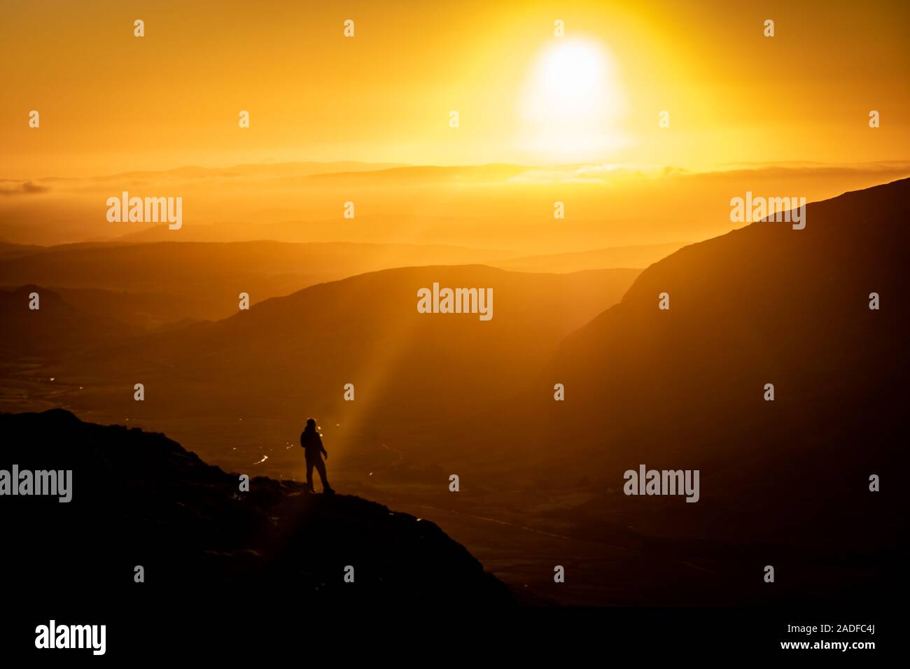 Silhouetted hiker in Snowdonia mountains at sunset Stock Photo - Alamy