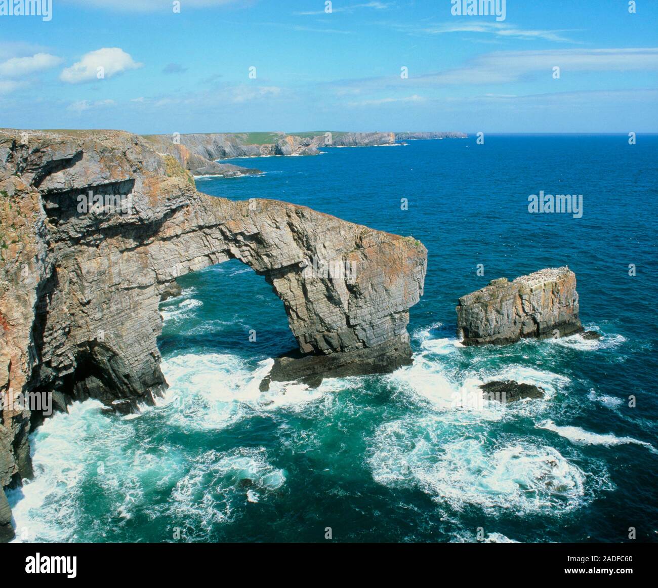 Sea arch. Sea arch projecting from a cliff. To the right of the arch is ...