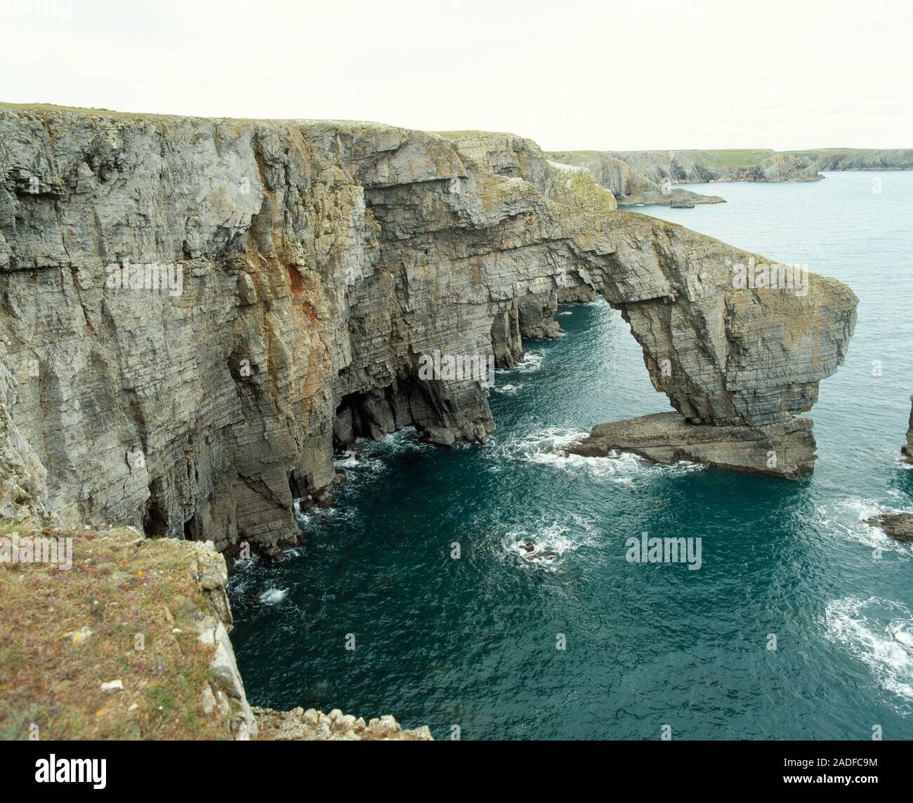 Sea arch. Sea arch projecting from a cliff into the sea. Sea arches are ...