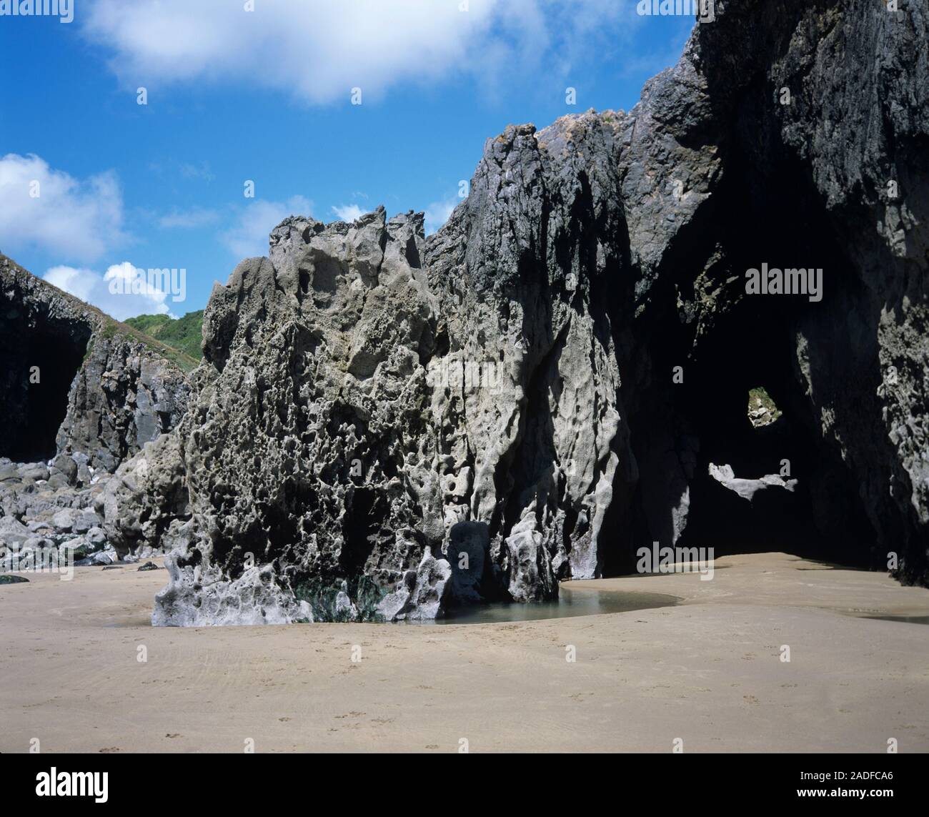 Coastal erosion. Limestone cliffs eroded into tunnels, caves and ...