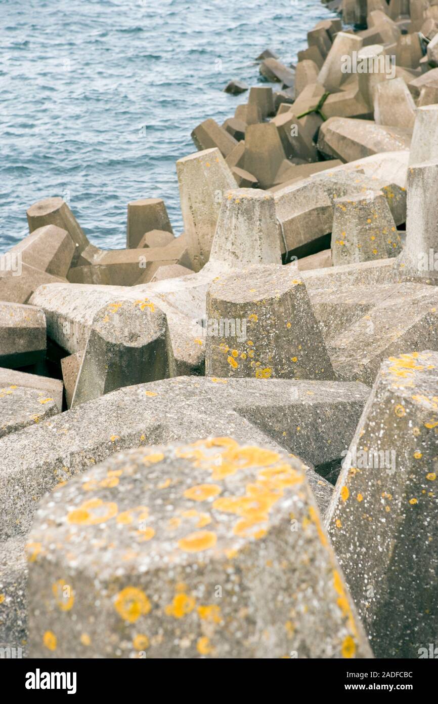 Coastal defence. Precast concrete blocks along a shore. This type of ...