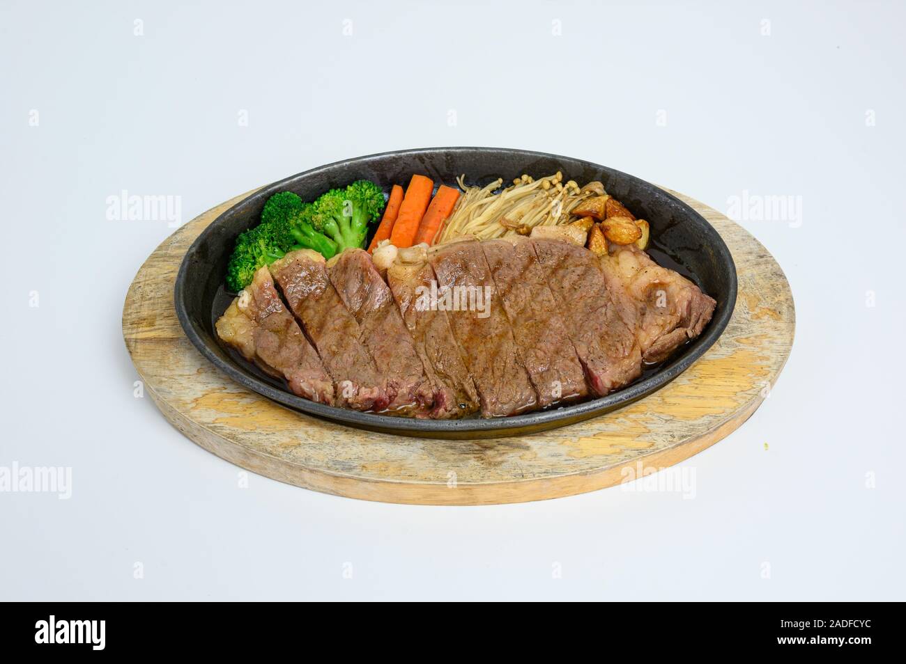 Japanese wagyu beef slices set with vegetables in pan on wooden tray ...