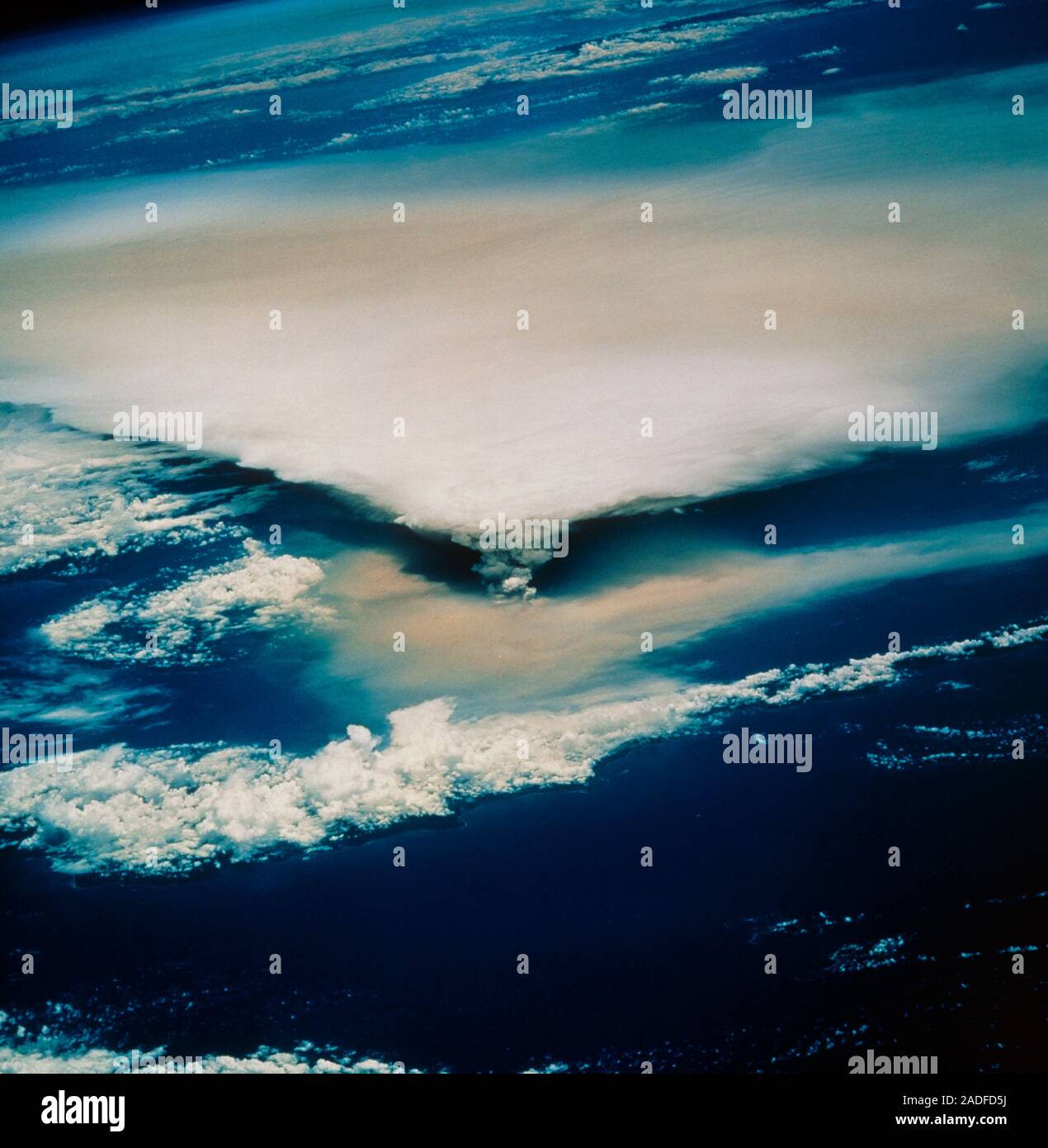 Volcanic eruption seen from space. The large white cloud at the top of ...