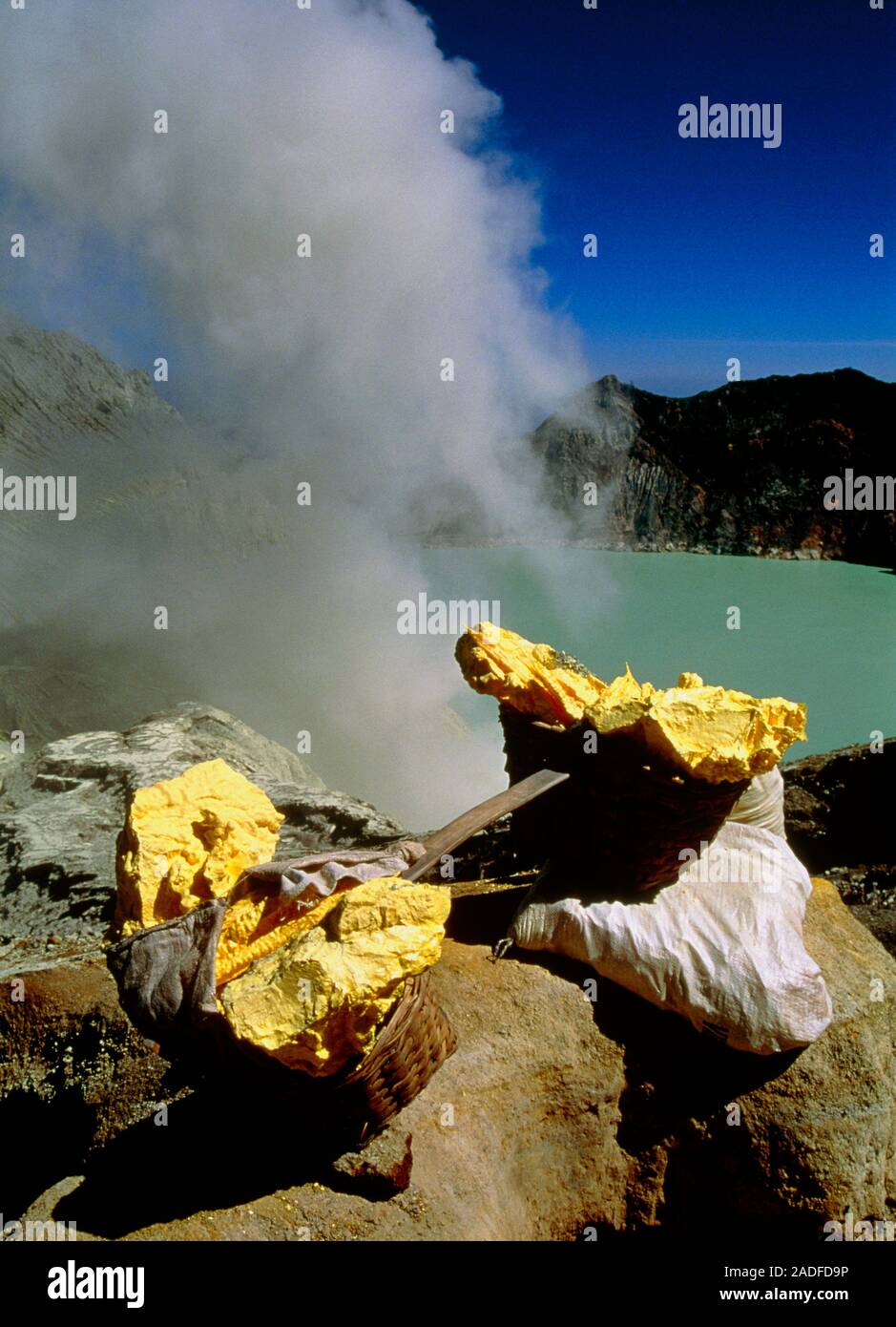 Volcanic sulphur mining. Baskets full of sulphur (yellow) before ...
