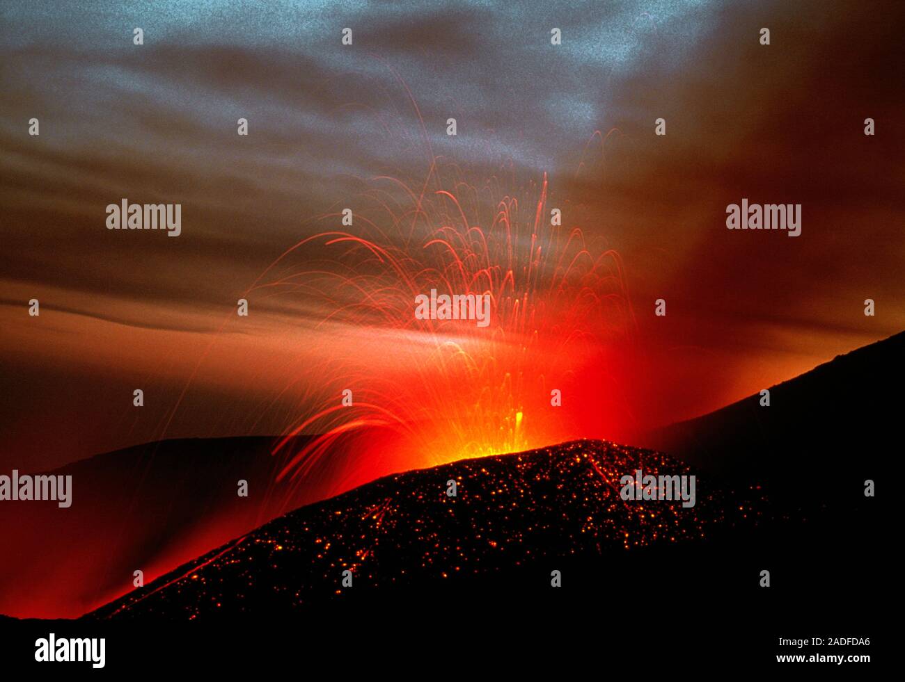 Mount Etna volcano erupting at night and throwing out glowing lava ...