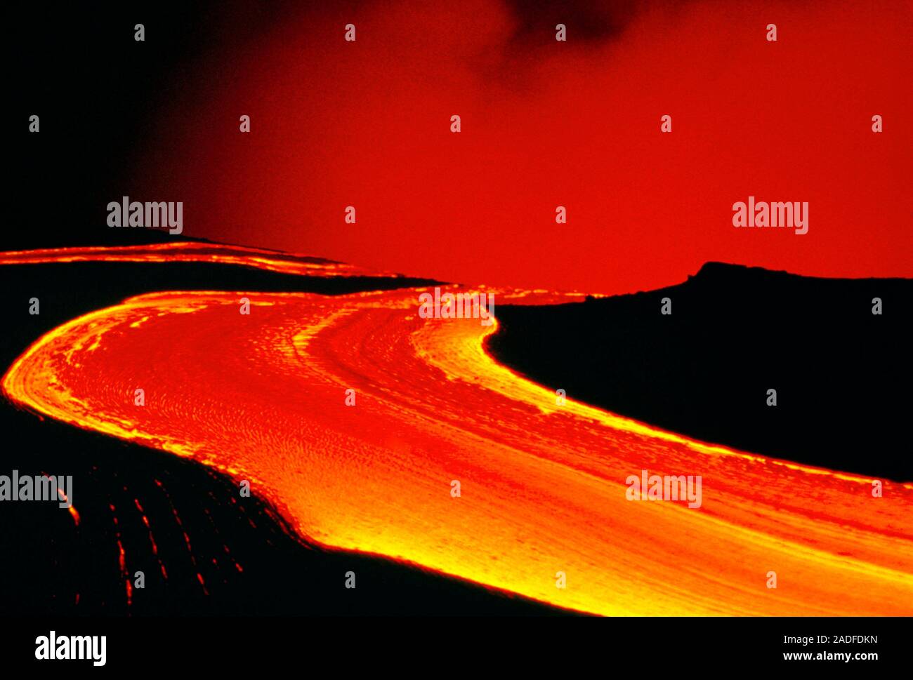 Lava flow. Lava flow approaching the shoreline. Lava is molten rock ...