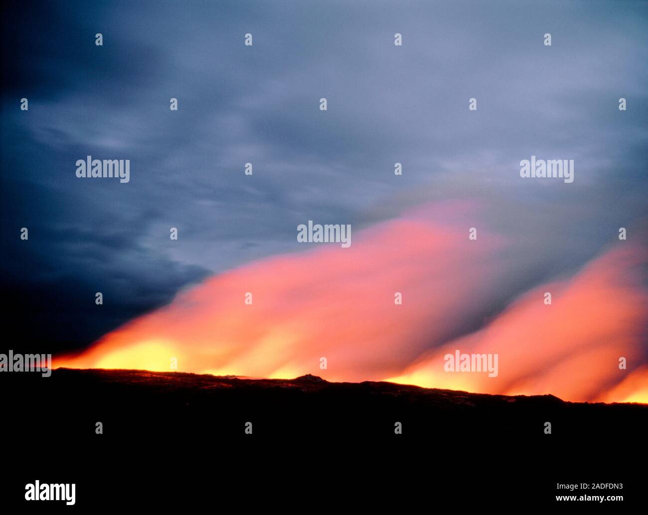 Lava flow. Rising steam illuminated by lava flowing into the ocean at ...