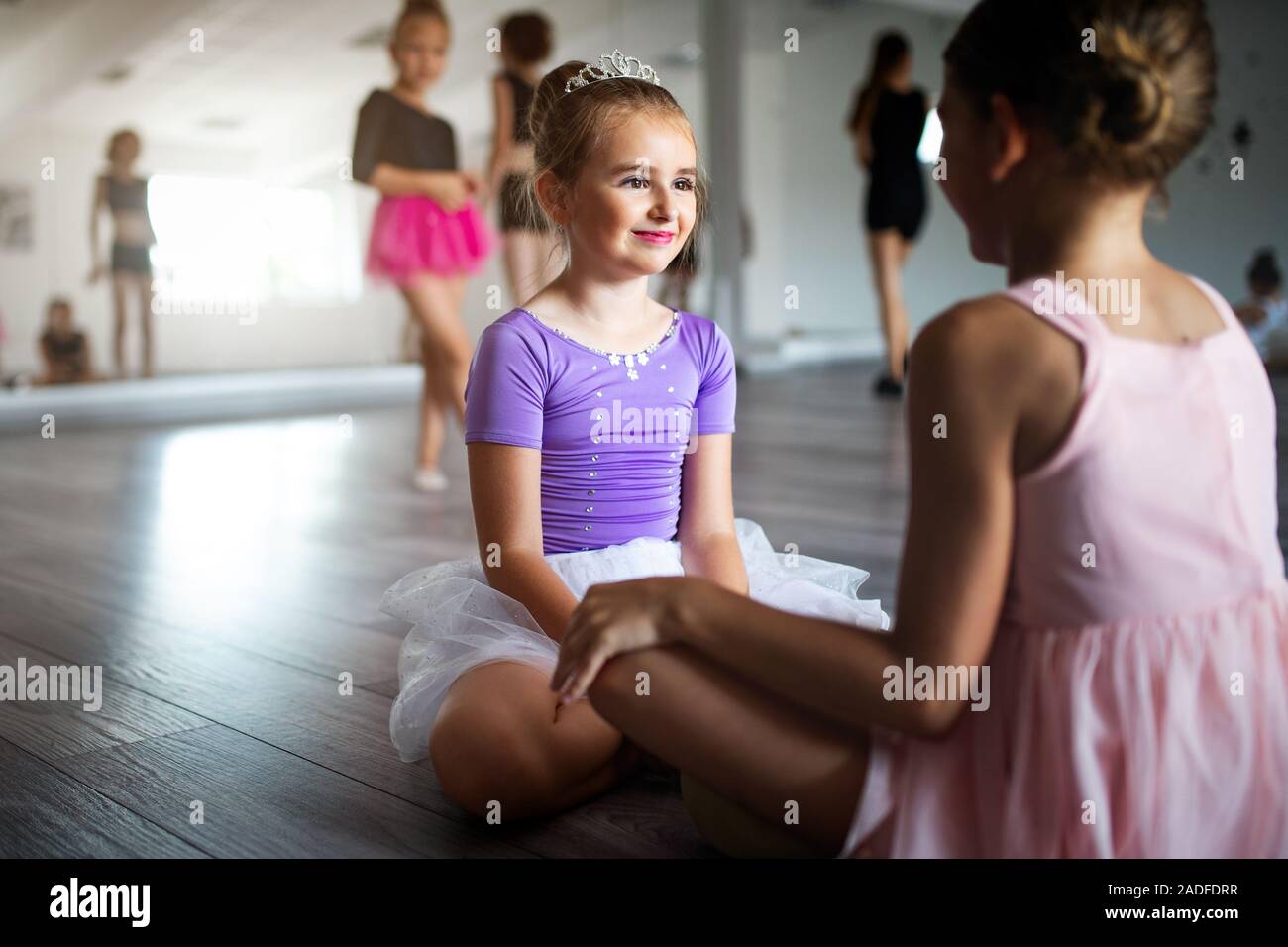 Group of fit happy children exercising ballet in studio together Stock ...