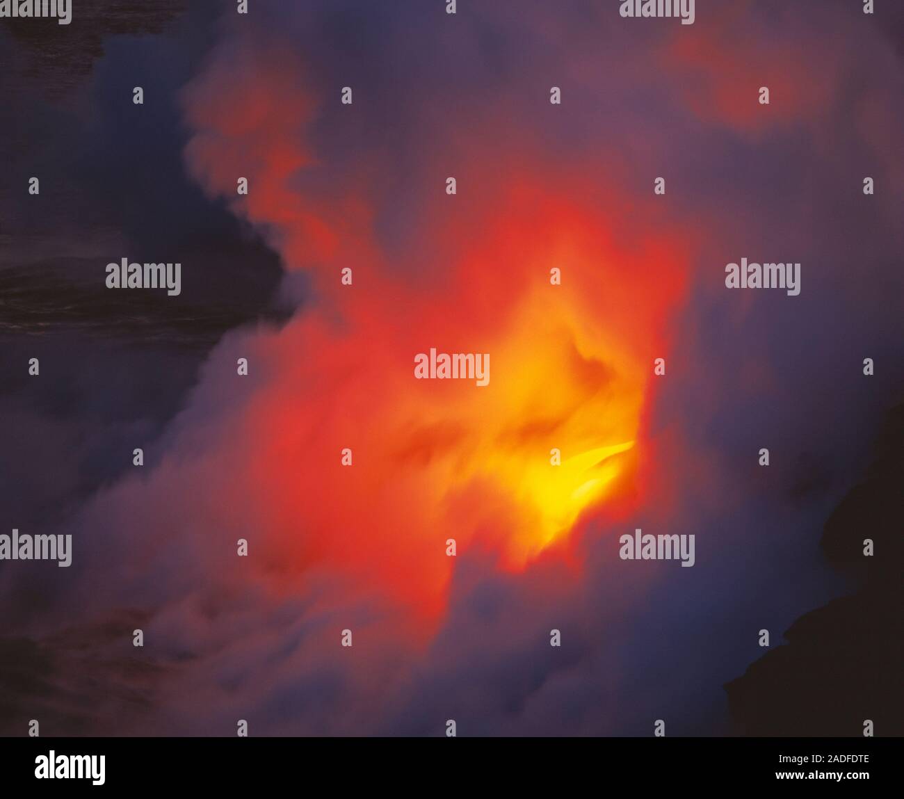 Pahoehoe lava. Steam rising as a flow of pahoehoe lava from Kilauea ...