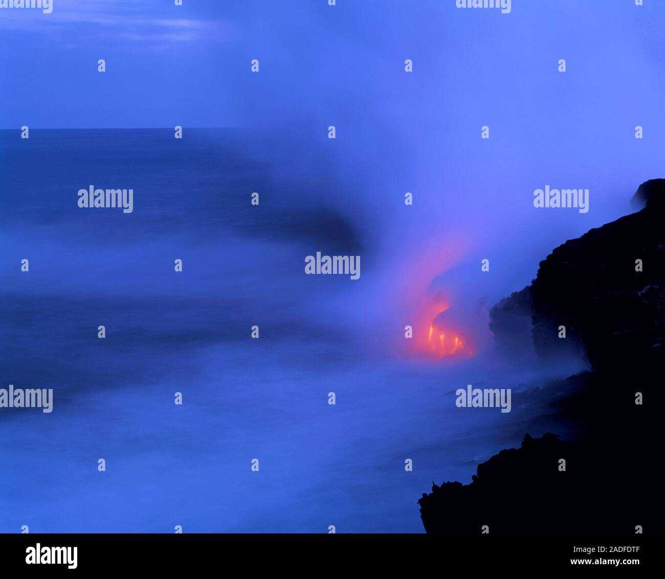 Pahoehoe lava. Steam rising as a flow of pahoehoe lava from Kilauea ...