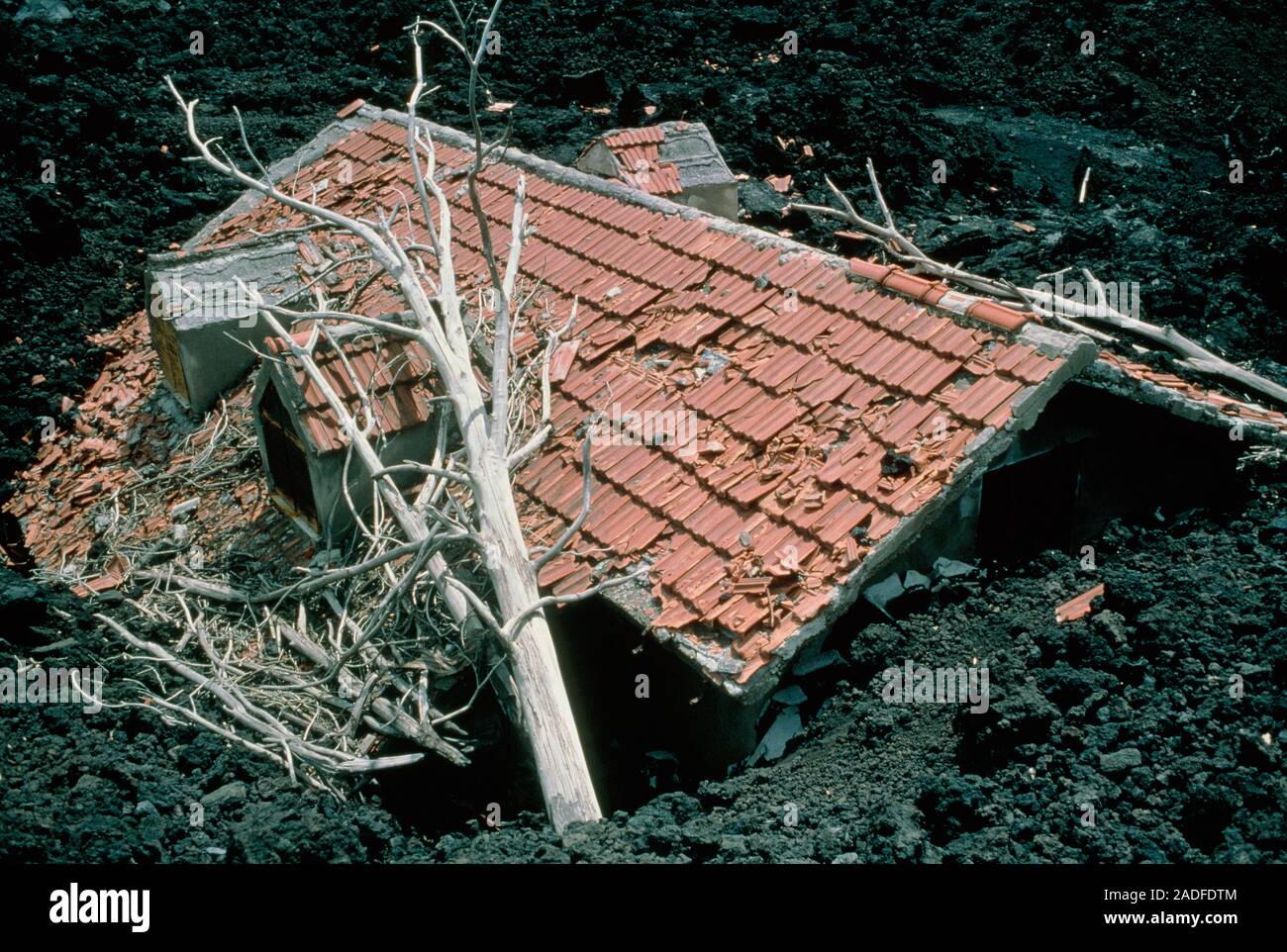 House caught in lava flow. View of a house surrounded by lava from ...