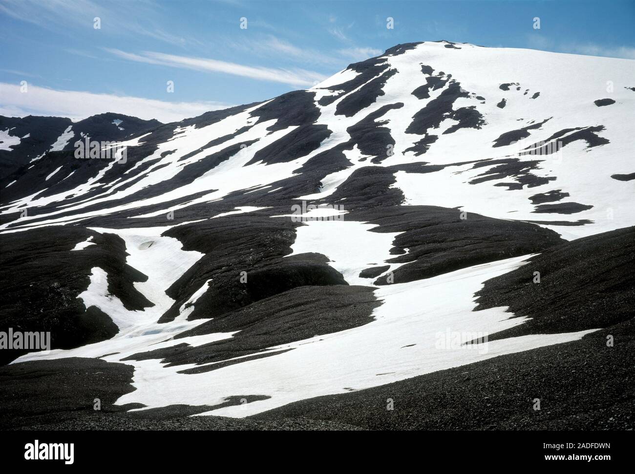 Volcanic tuff. Mountainside of black tuff or tuffstone, with remnants ...