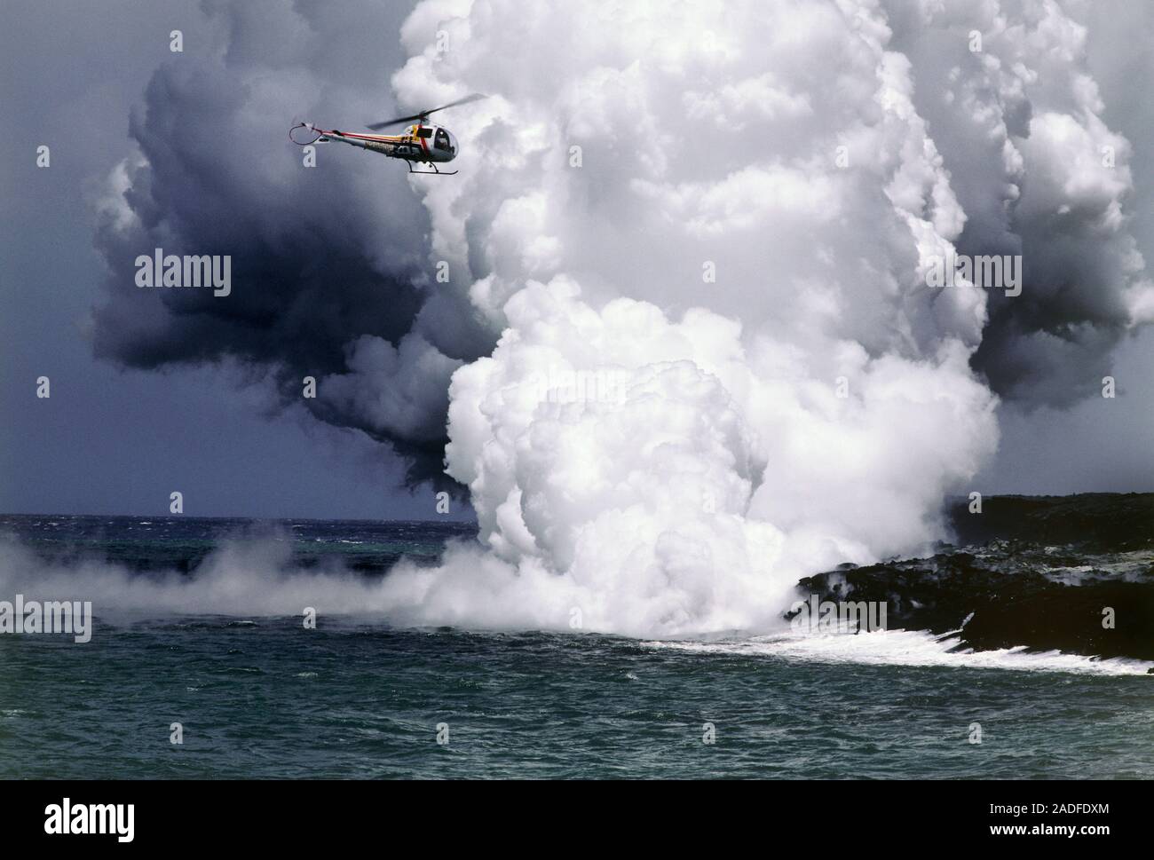 Lava flow boiling the sea. Helicopter flying near a cloud of steam ...