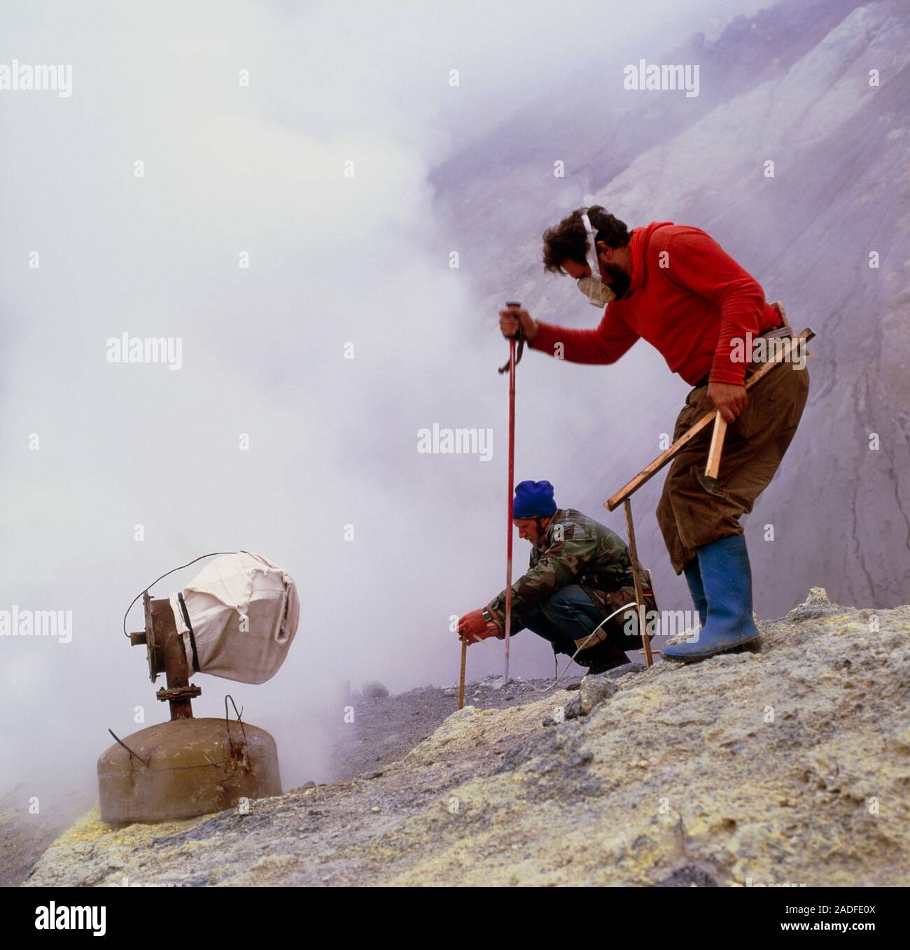 Volcanologists. View of volcanologists sampling sulphur deposits around ...