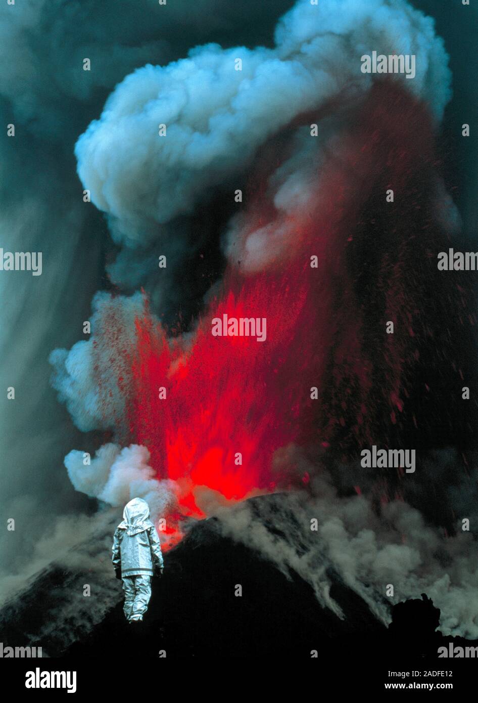 Volcanologist wearing a heat suit as he watches an eruption of glowing ...